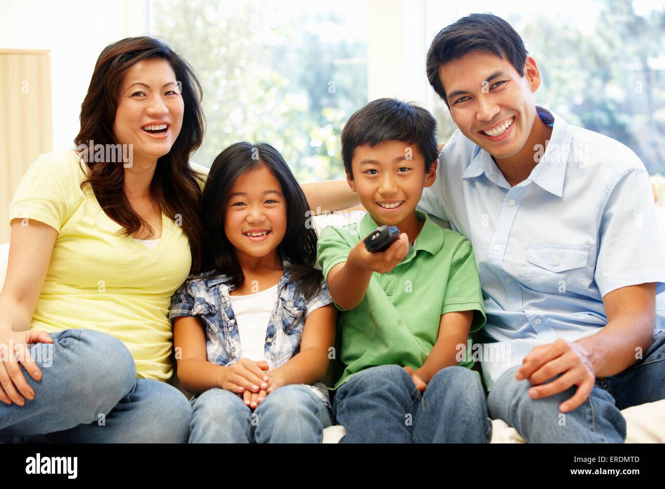 Asian family watching television Stock Photo - Alamy
