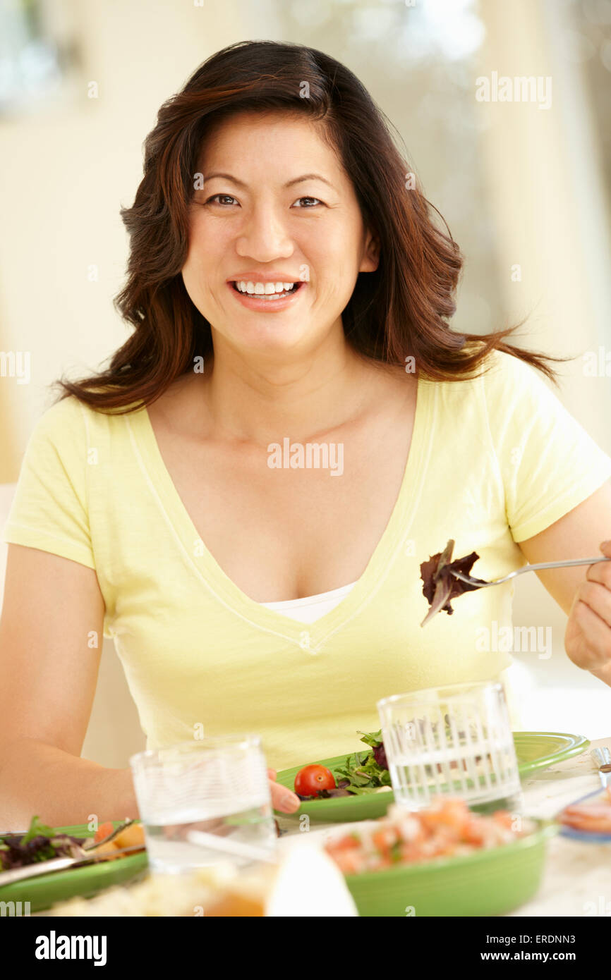 Asian woman eating meal at home Stock Photo - Alamy