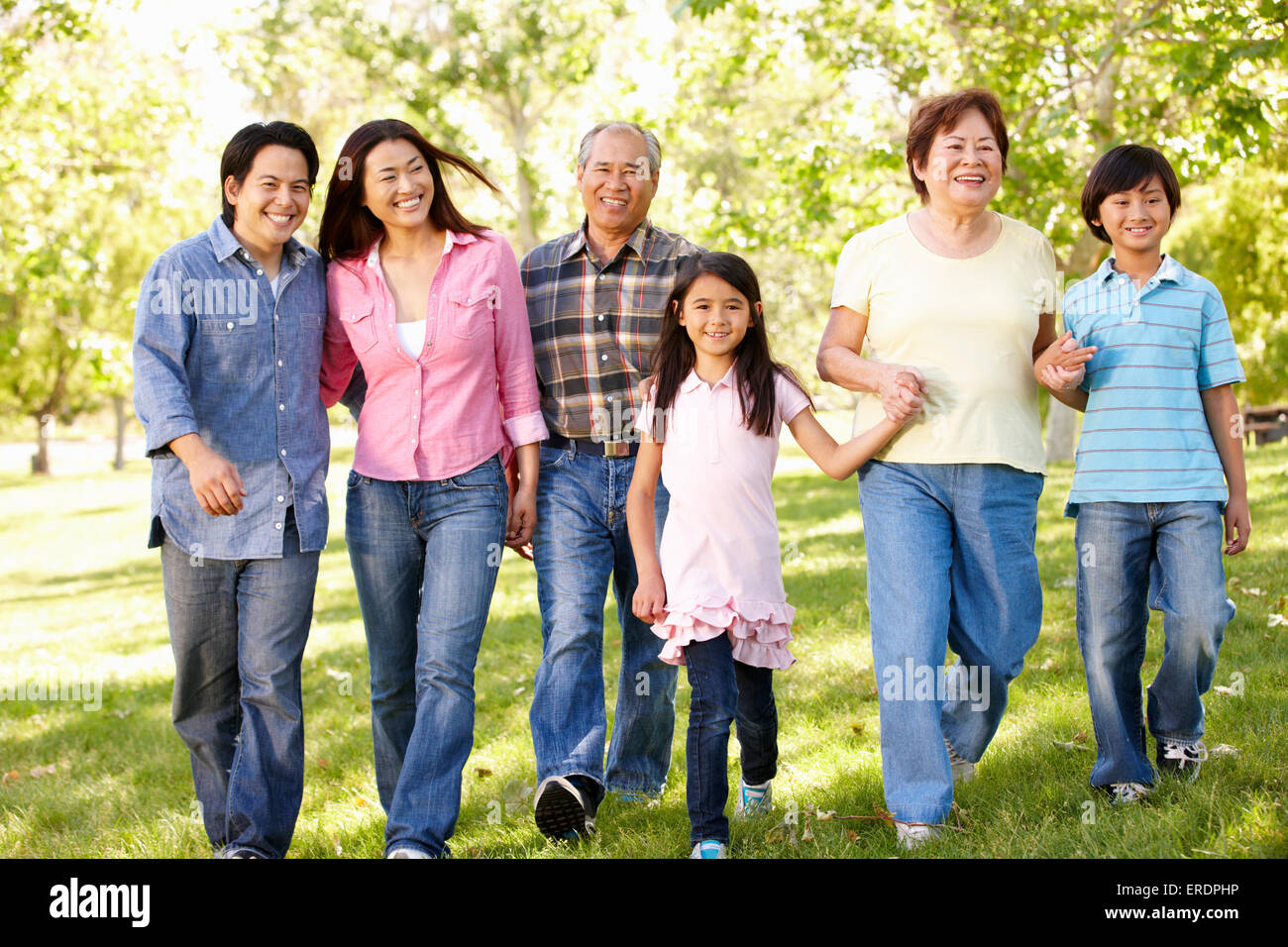Multi-generation Asian family walking in park Stock Photo - Alamy