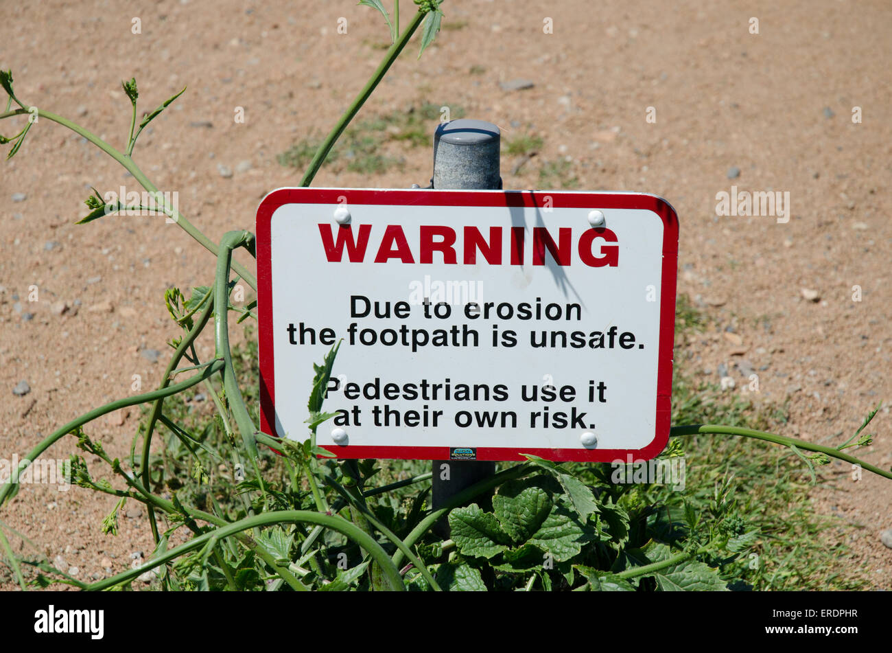 Warning sign for footpath erosion and pedestrian risk Stock Photo - Alamy