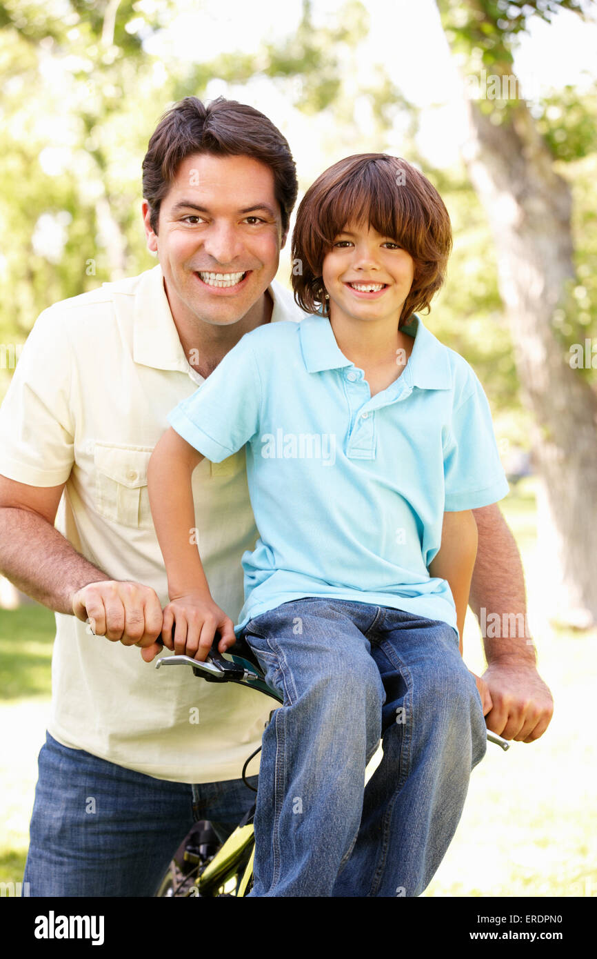 Young Hispanic Father And Son Cycling In Park Stock Photo - Alamy