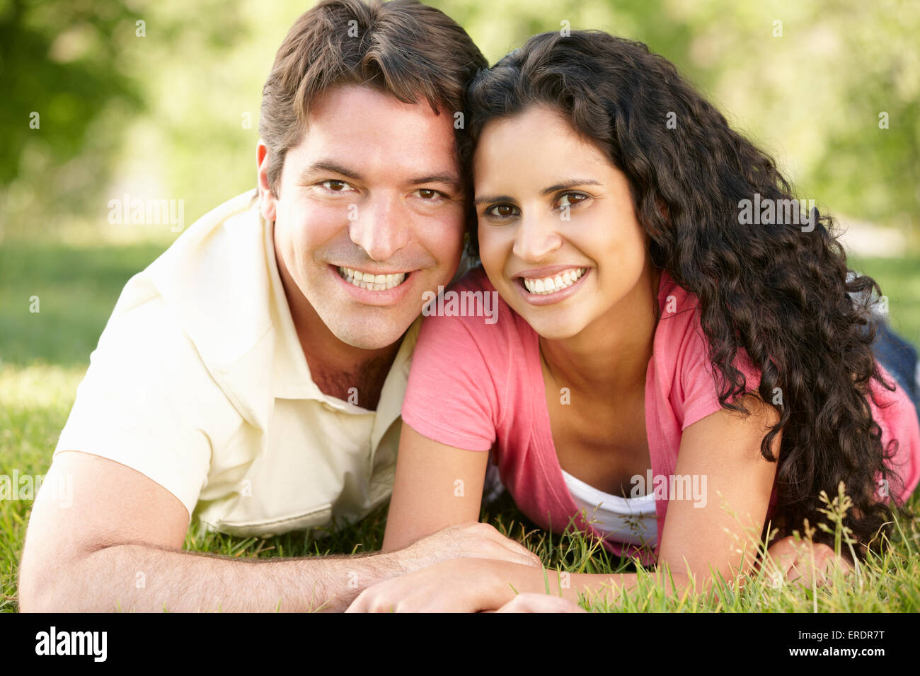 Romantic Young Hispanic Couple Relaxing In Park Stock Photo - Alamy