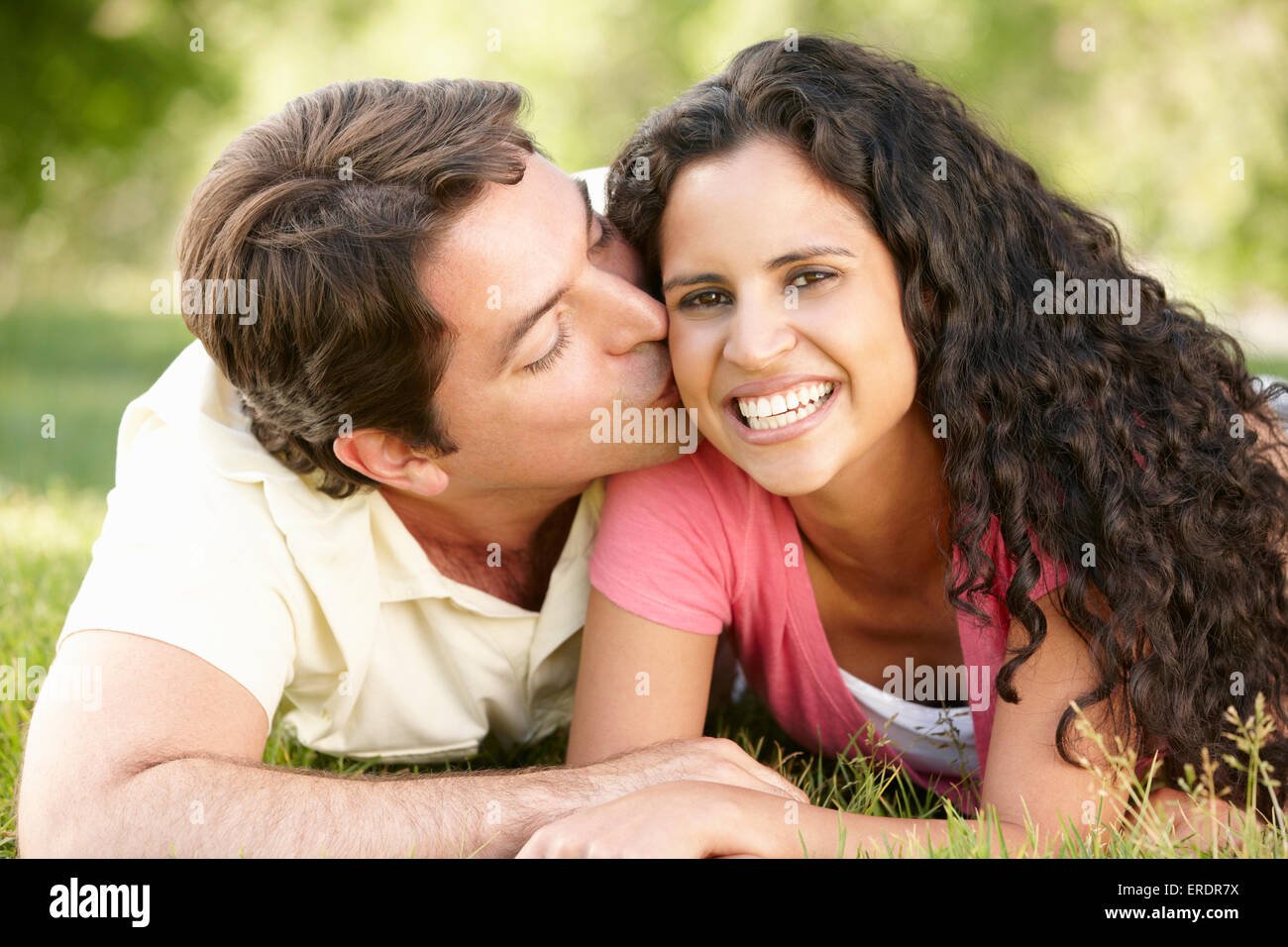 Romantic Young Hispanic Couple Relaxing In Park Stock Photo - Alamy