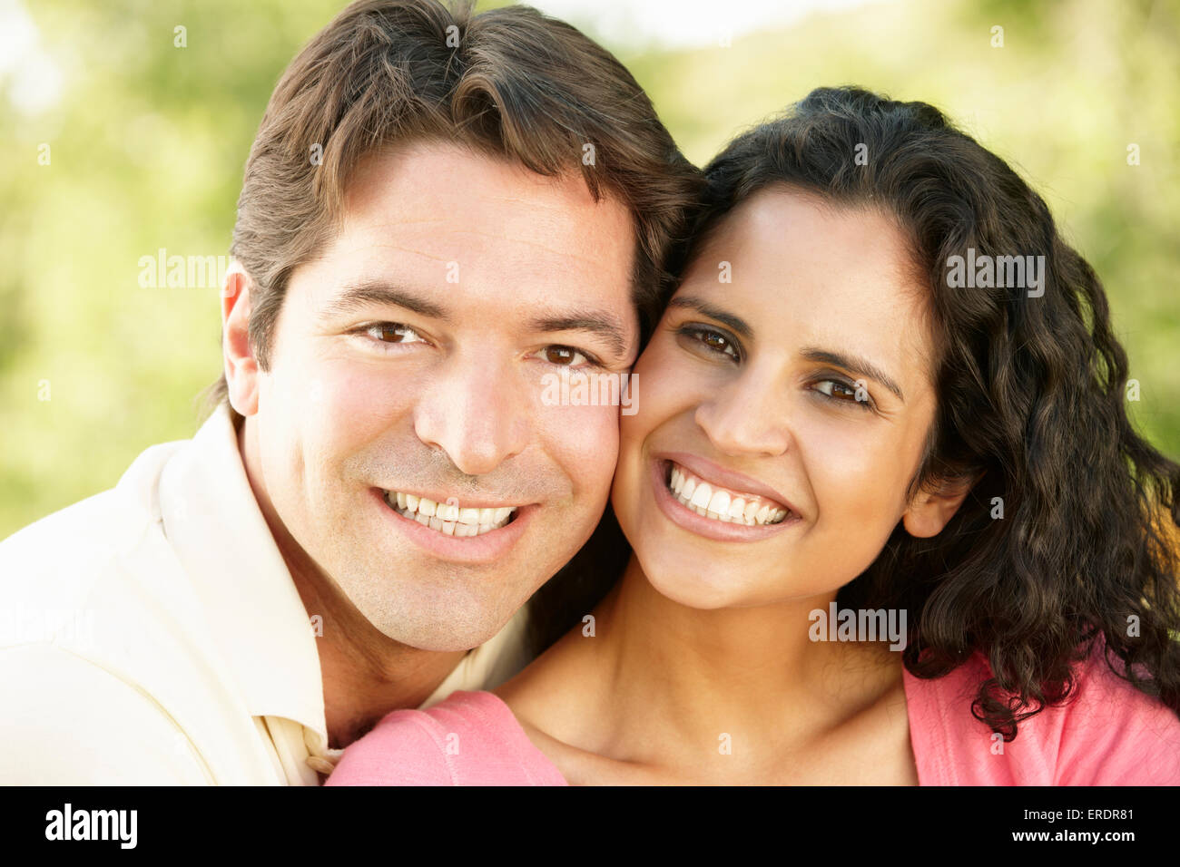 Romantic Young Hispanic Couple Relaxing In Park Stock Photo - Alamy