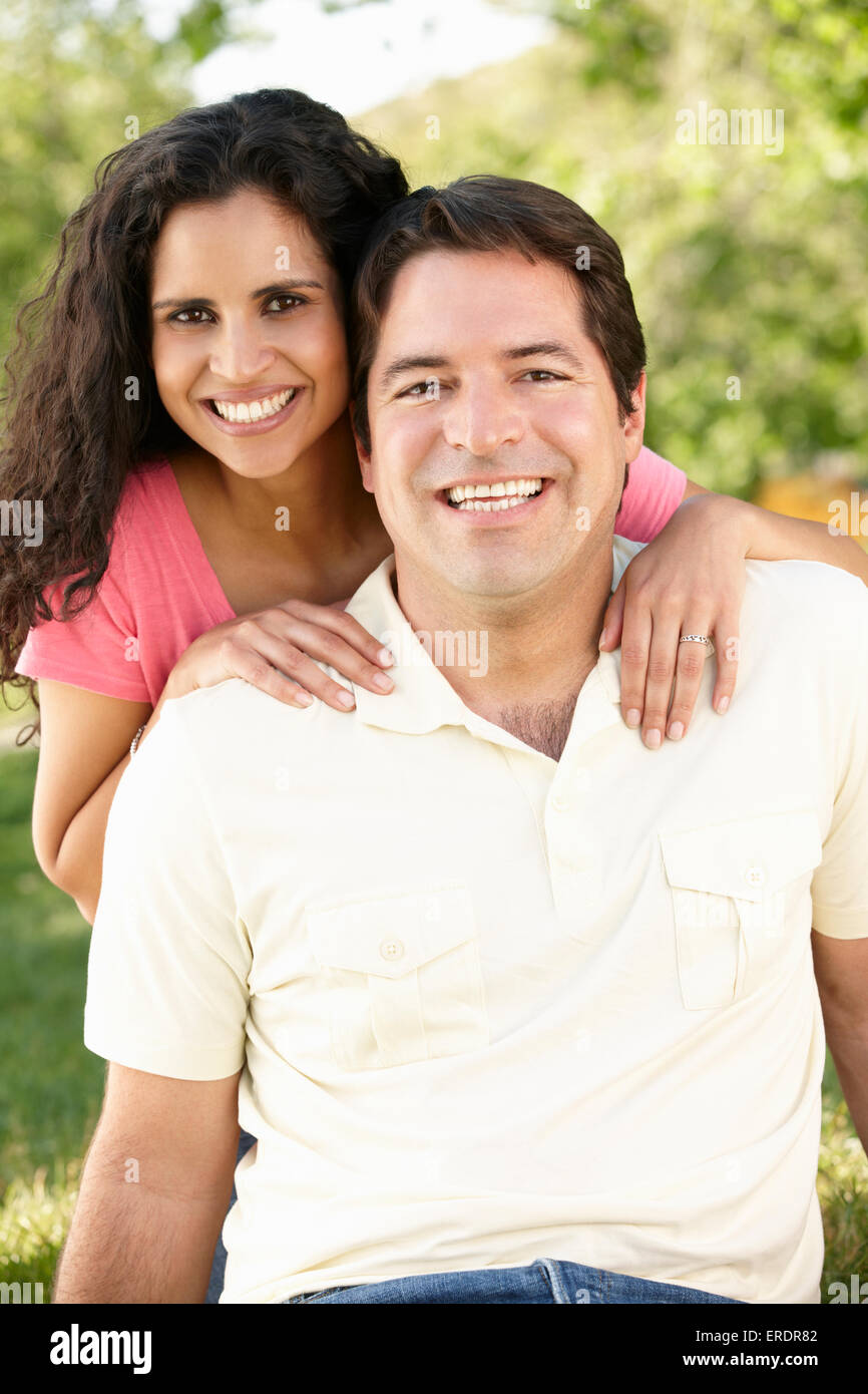 Romantic Young Hispanic Couple Relaxing In Park Stock Photo - Alamy