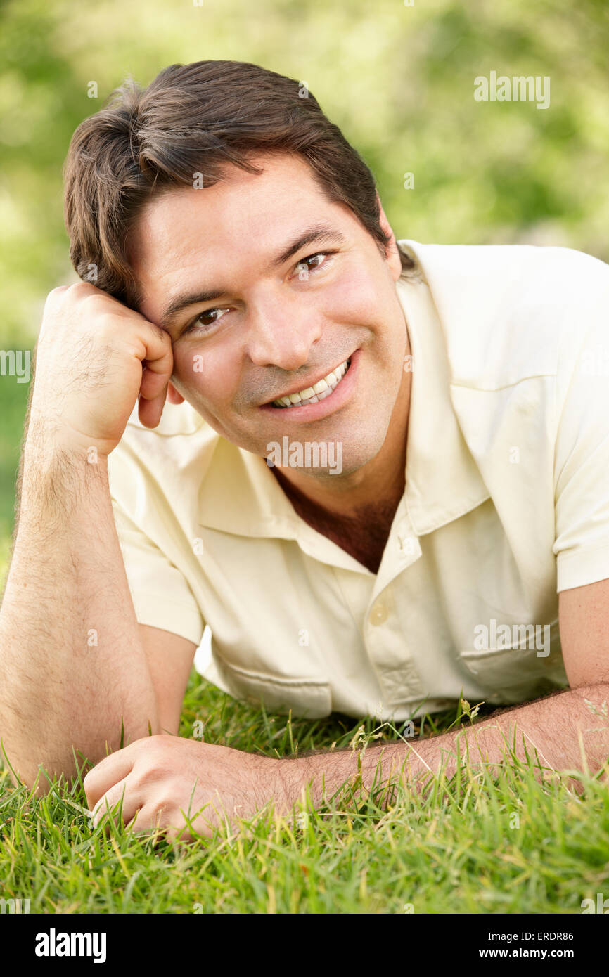 Young Hispanic Man Relaxing In Park Stock Photo - Alamy