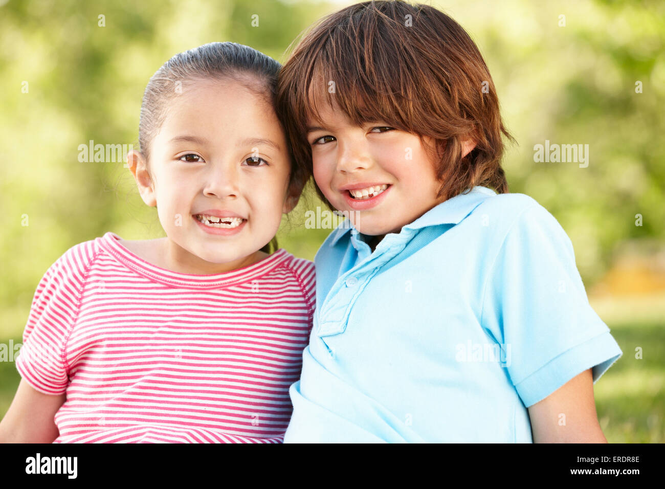 Hispanic Children Relaxing In Park Stock Photo - Alamy