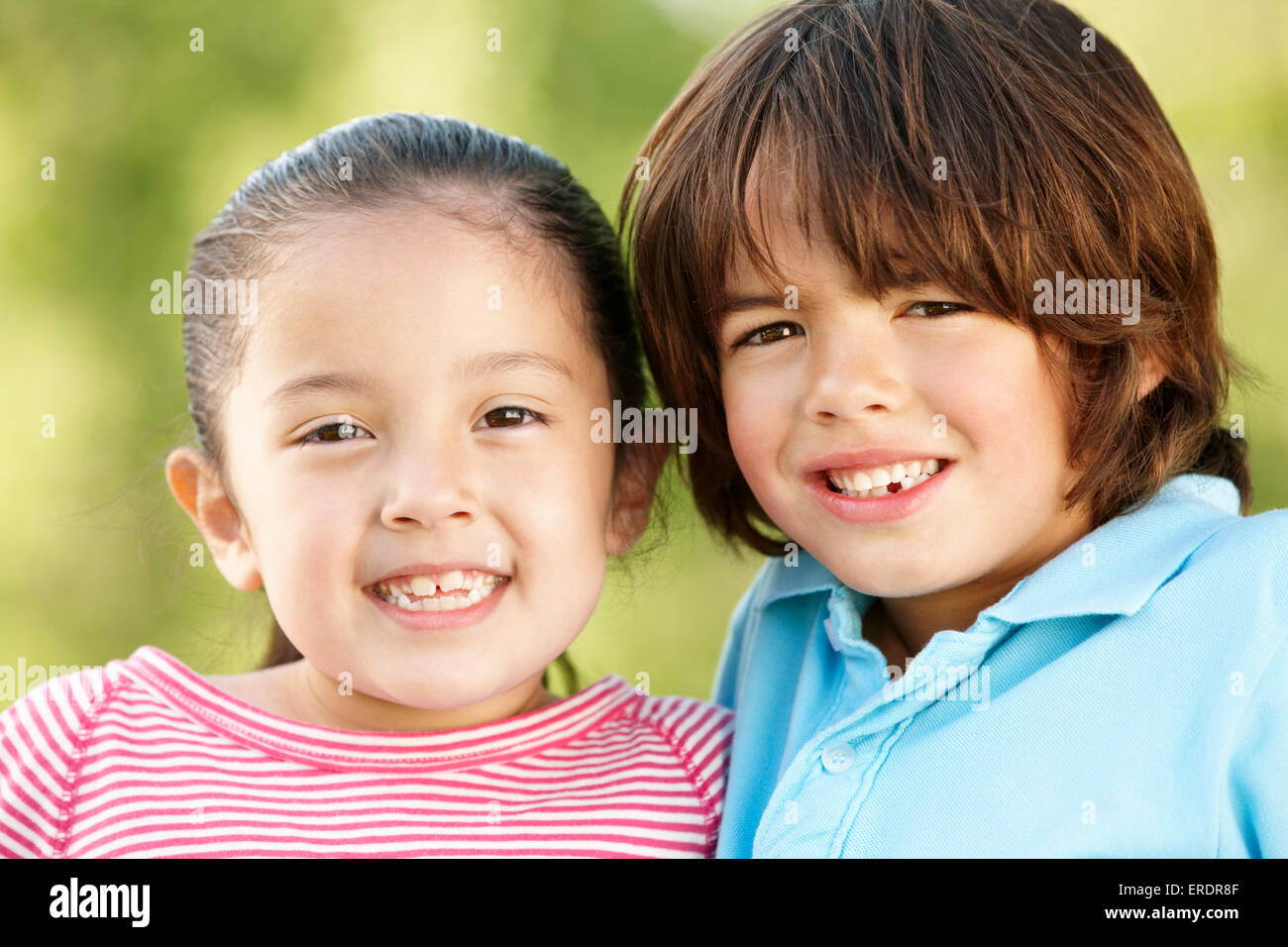 Hispanic Children Relaxing In Park Stock Photo - Alamy