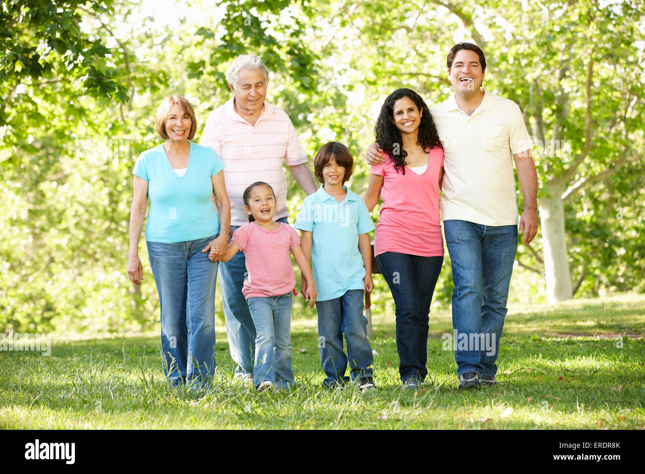 Multi Generation Hispanic Family Walking In Park Stock Photo - Alamy