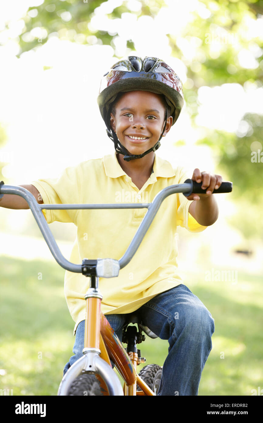 Boy Riding Bike In Park Stock Photo - Alamy