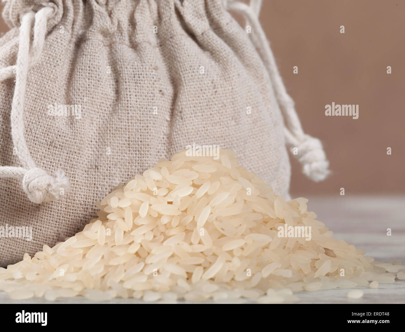 burlap sack full of rice Stock Photo - Alamy