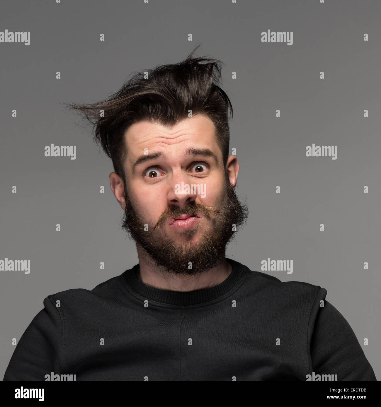 Portrait of young tousled man in studio Stock Photo - Alamy