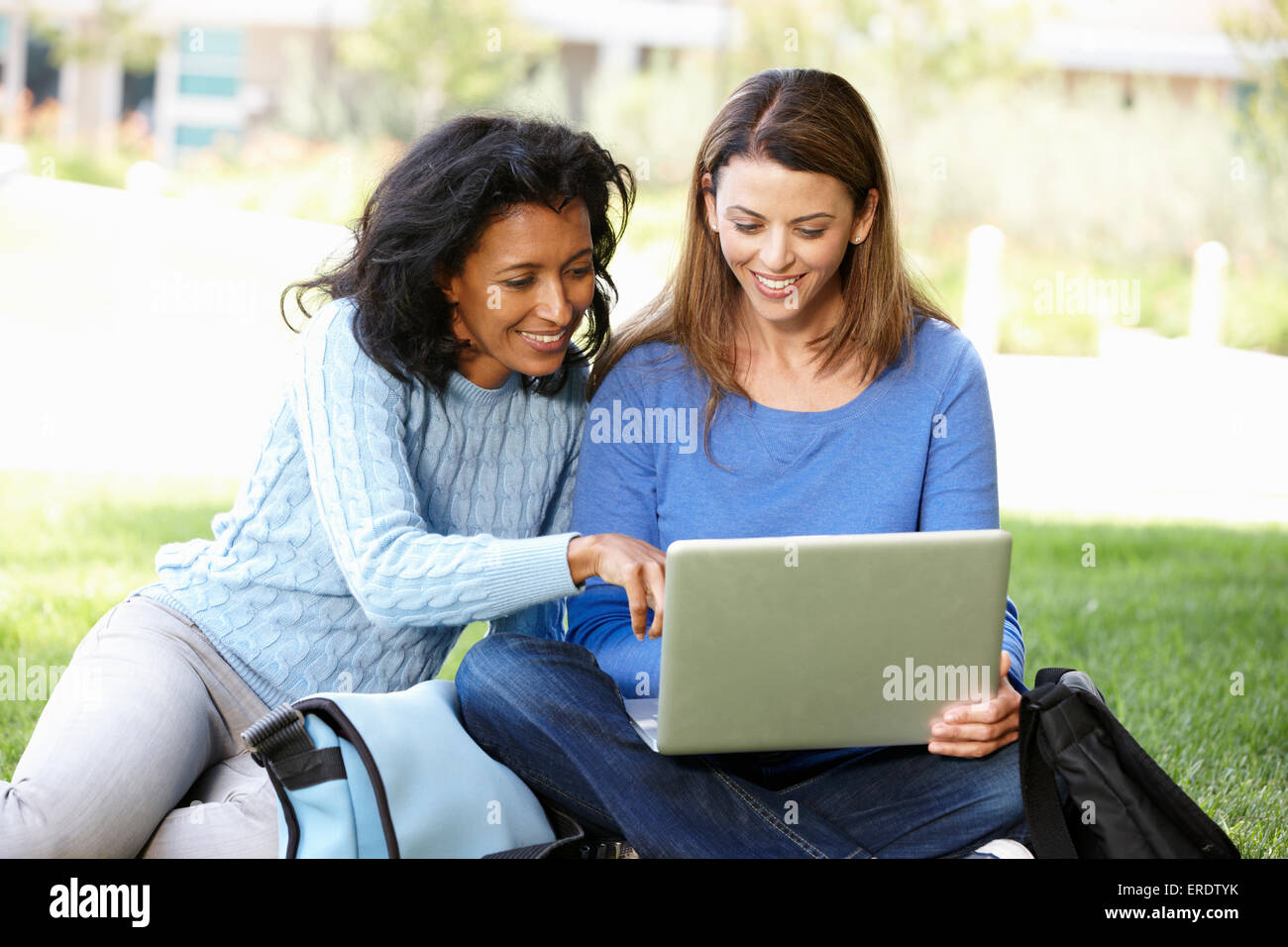 Women using laptop outdoors Stock Photo - Alamy