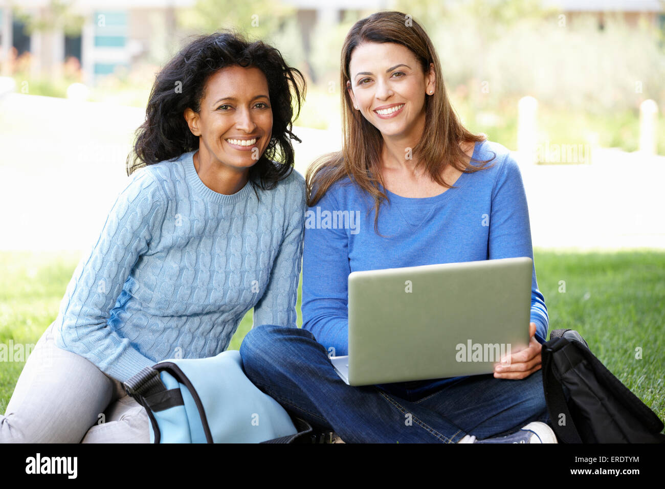 Women using laptop outdoors Stock Photo - Alamy