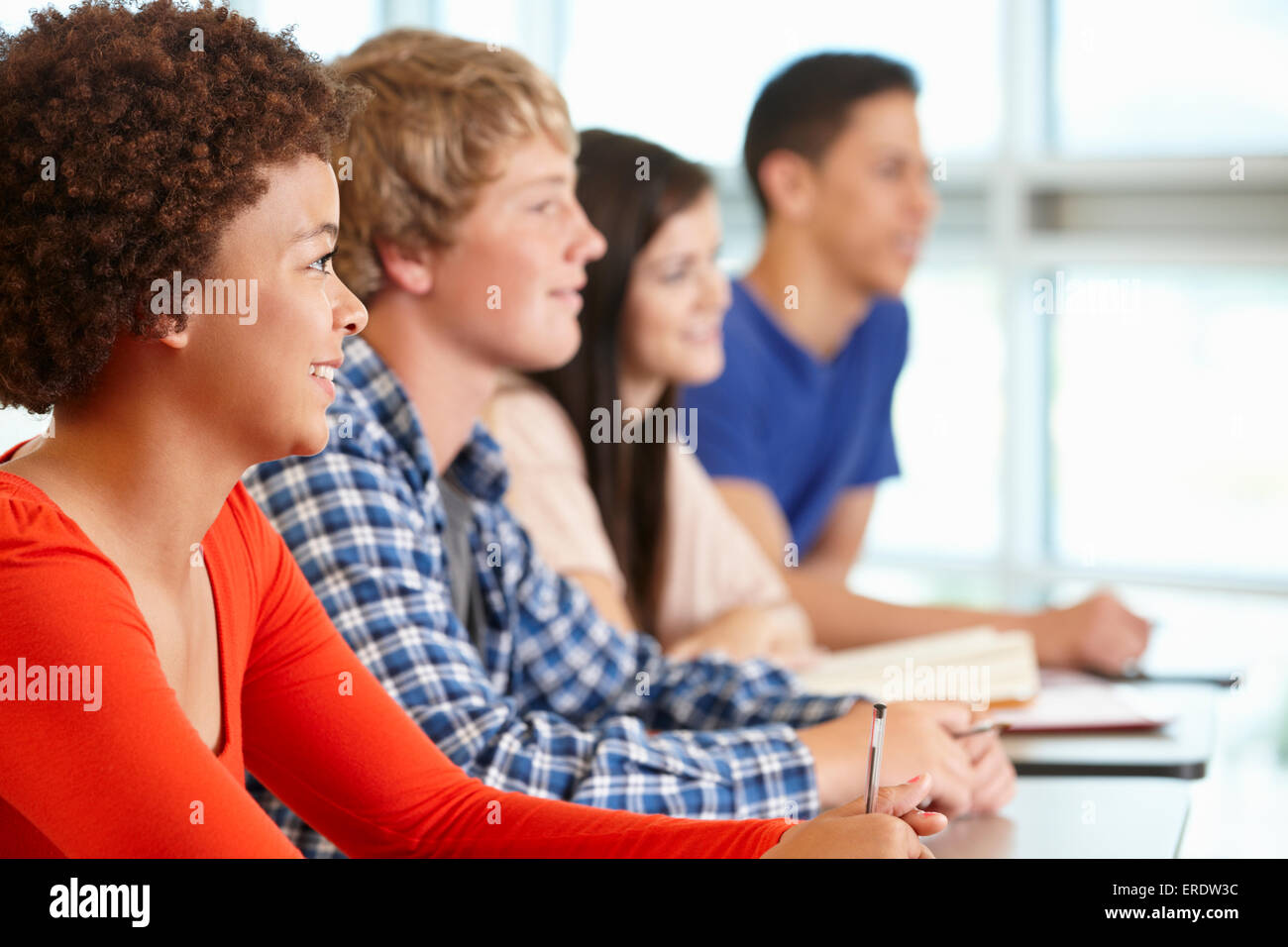 Multi racial teenage pupils in class Stock Photo - Alamy