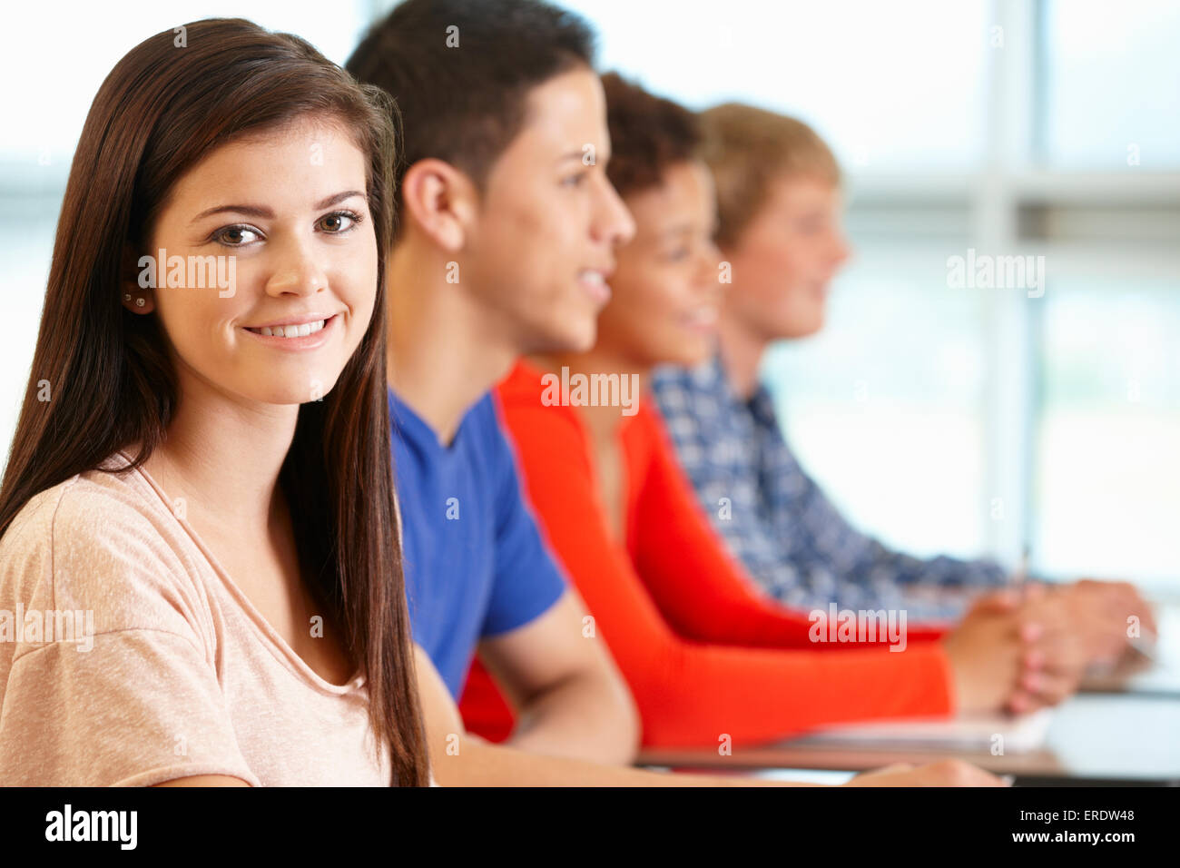 Multi racial teenage pupils in class, one smiling to camera Stock Photo ...