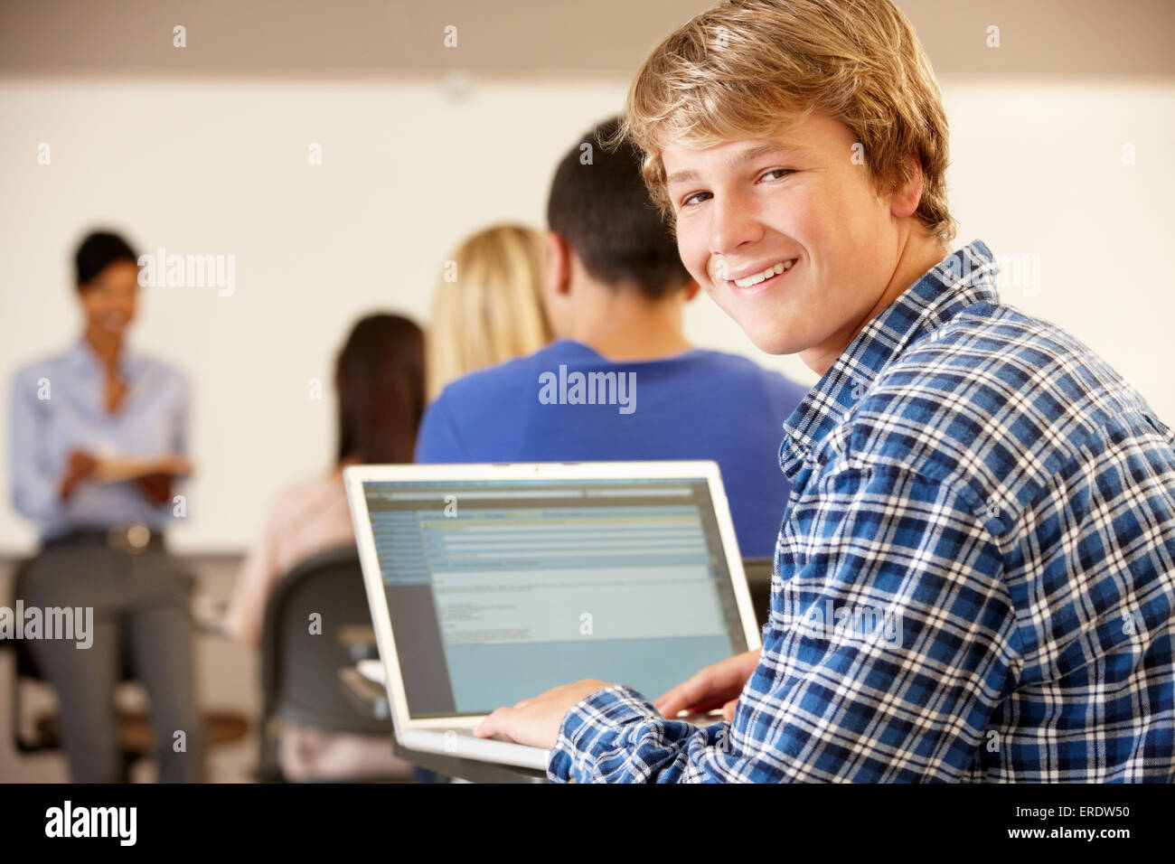 Happy pupils using laptop class hi-res stock photography and images - Alamy
