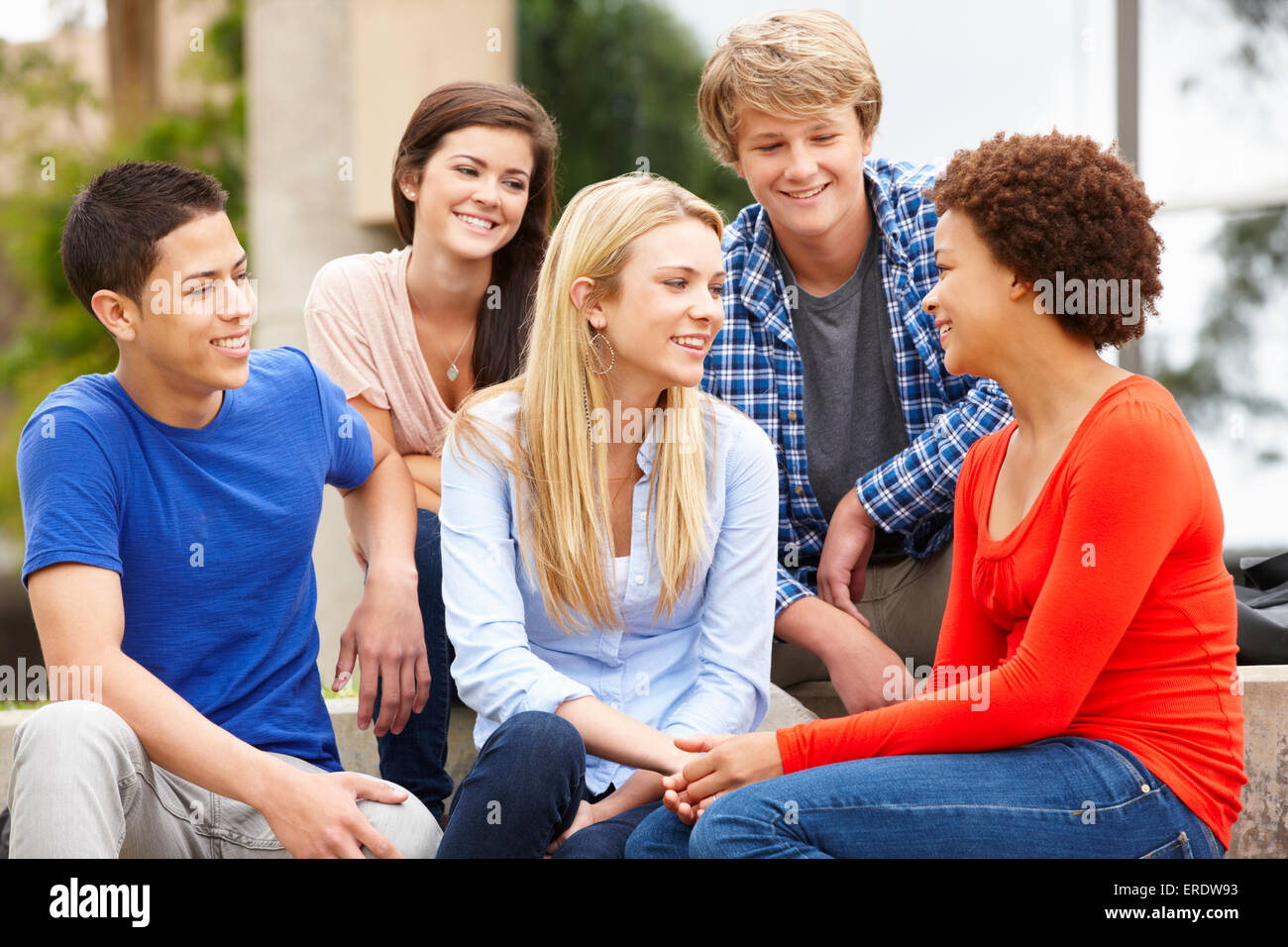 Multi racial student group sitting outdoors Stock Photo - Alamy