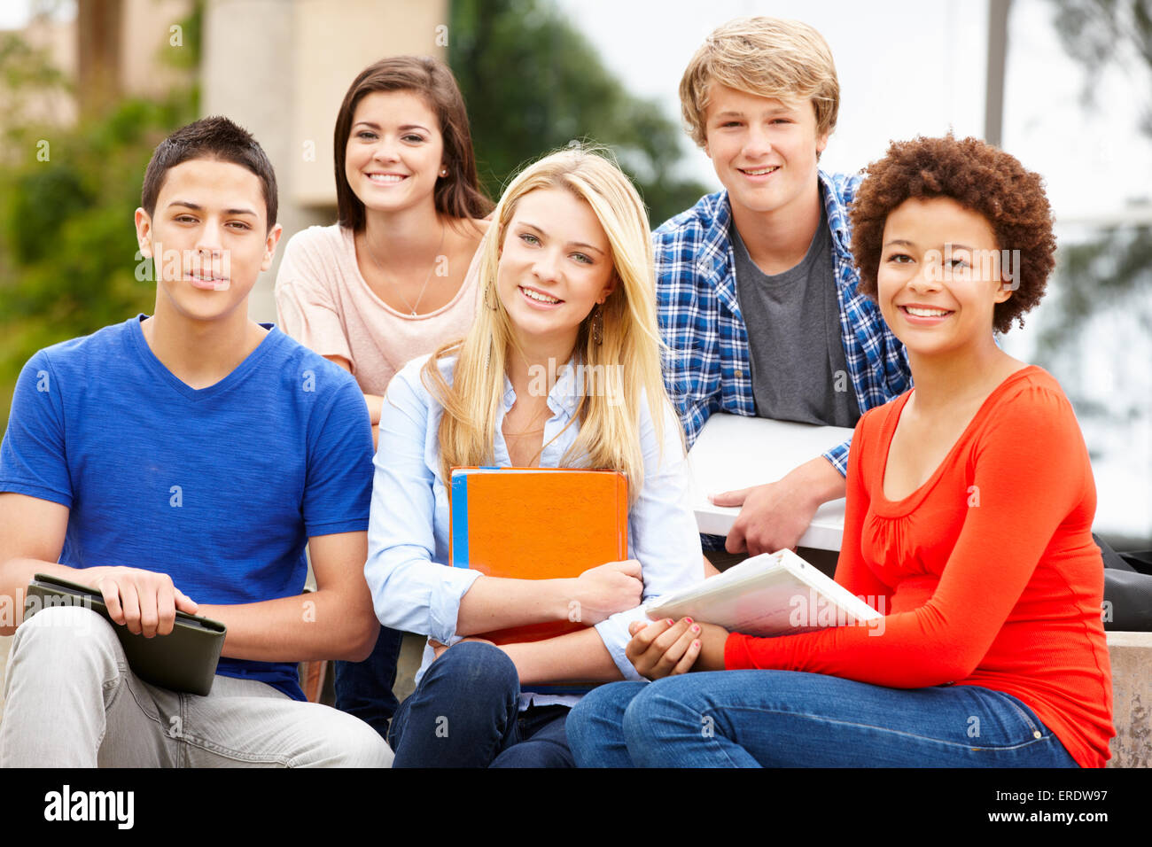 Multi racial student group sitting outdoors Stock Photo - Alamy