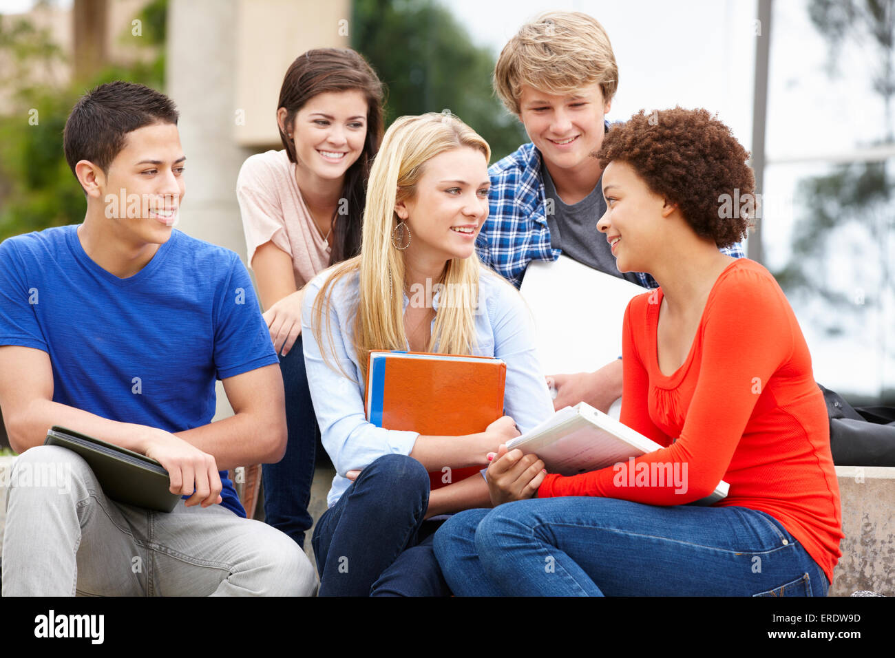 Multi racial student group sitting outdoors Stock Photo - Alamy
