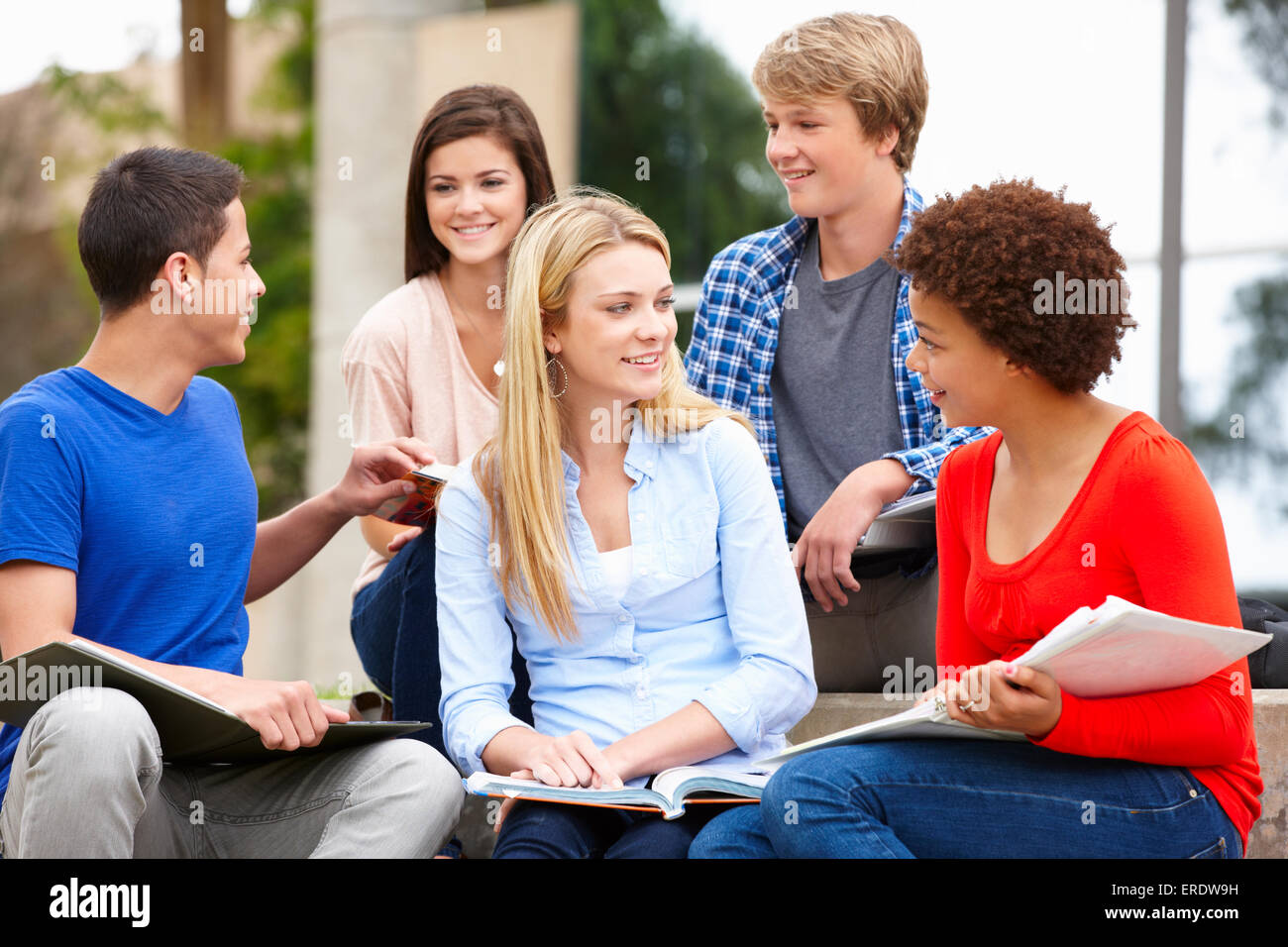 Multi racial student group sitting outdoors Stock Photo - Alamy