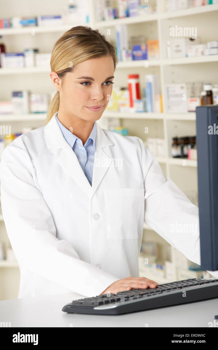 Pharmacist working on computer in pharmacy Stock Photo - Alamy
