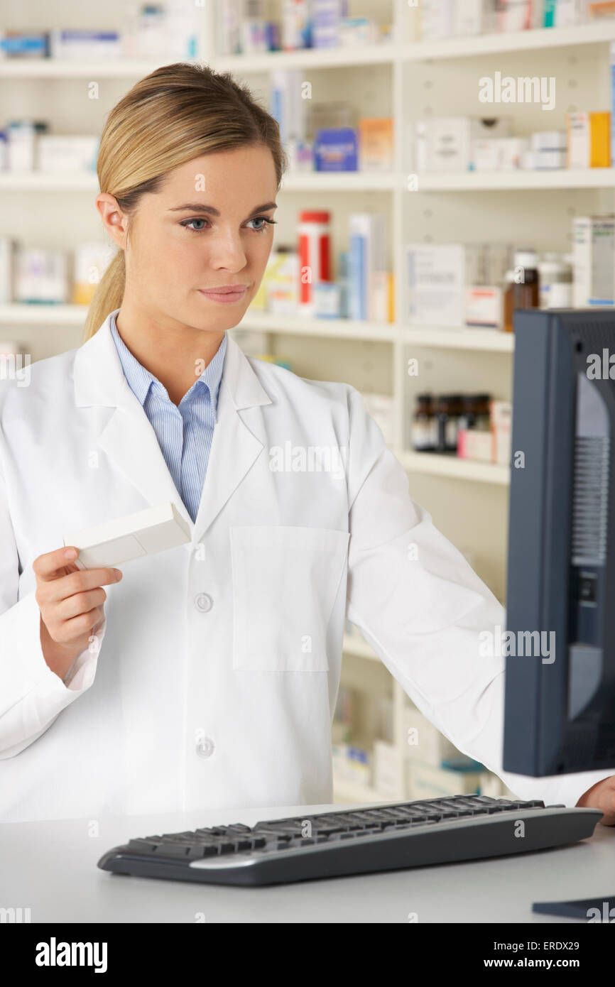 Pharmacist working on computer in pharmacy Stock Photo - Alamy