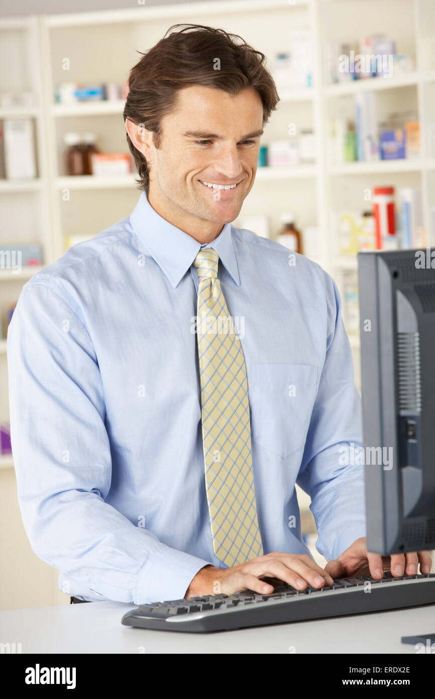 Pharmacist working on computer in pharmacy Stock Photo - Alamy