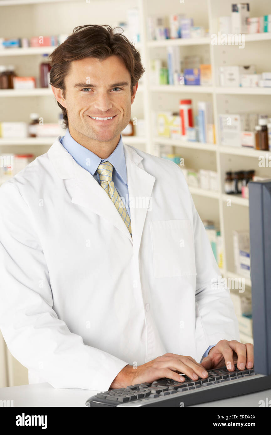 Pharmacist working on computer in pharmacy Stock Photo - Alamy