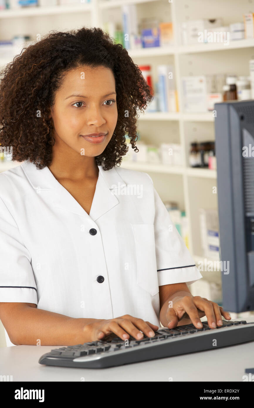 Nurse working on computer in pharmacy Stock Photo - Alamy