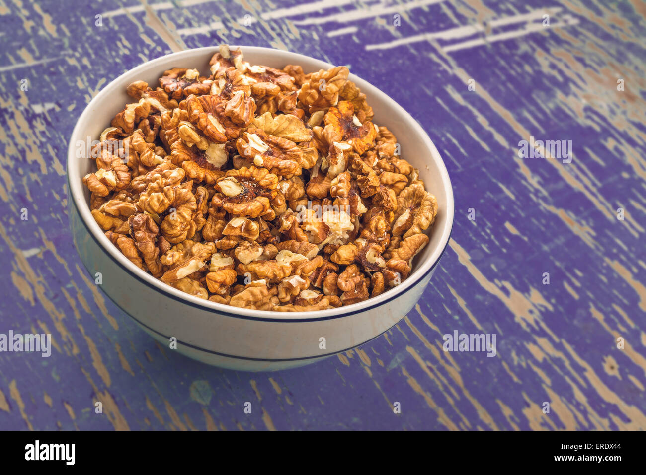 Peeled Walnuts in Ceramic Bowl on Purple Rustic Wood Plank Background ...