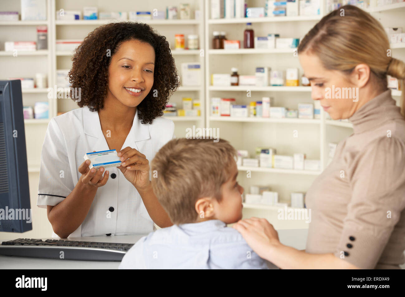 Pharmacist in pharmacy with mother and child Stock Photo - Alamy