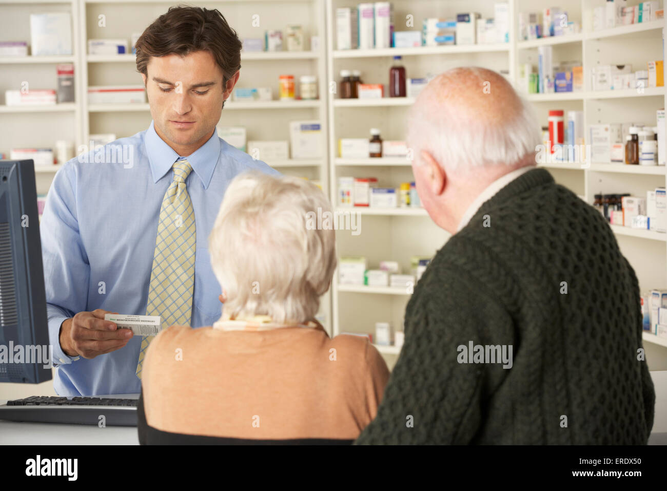 Pharmacist in pharmacy with senior couple Stock Photo - Alamy