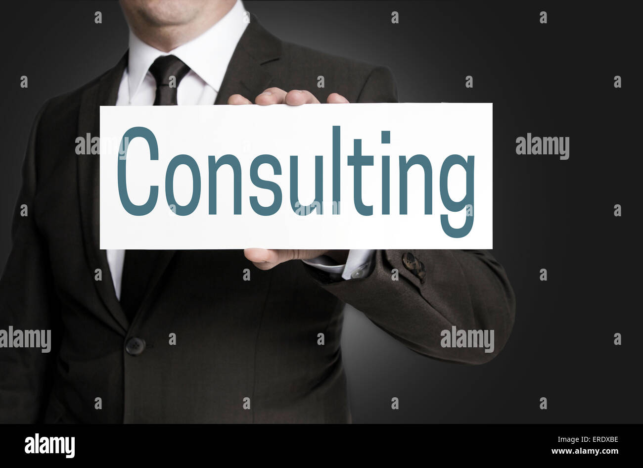 consulting sign is held by businessman Stock Photo - Alamy