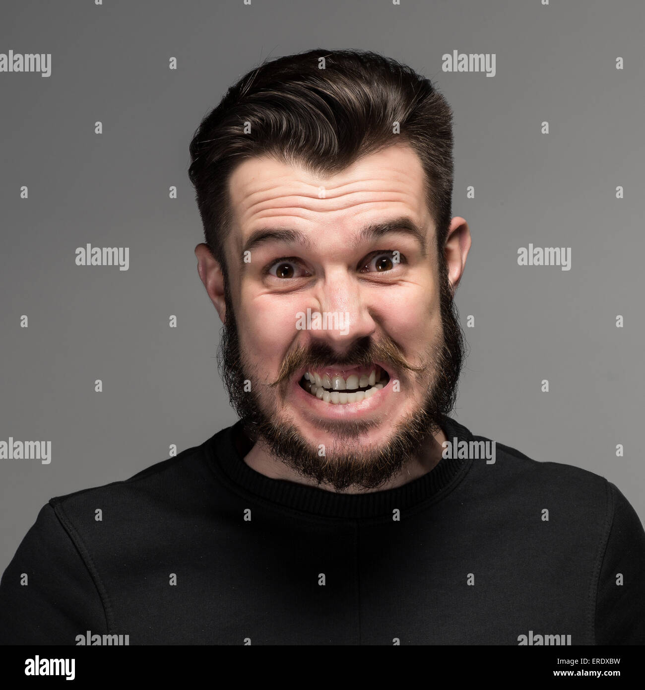 Portrait of young fierce man in studio Stock Photo - Alamy