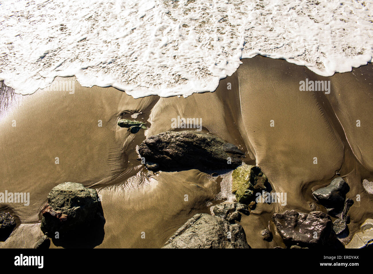 Ocean waves washing up on rocky beach Stock Photo - Alamy