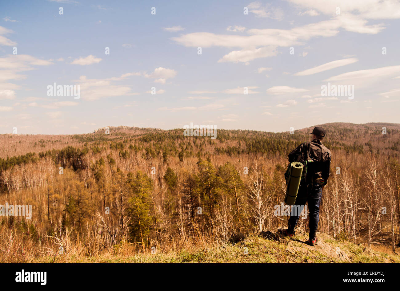 Caucasian man with camping gear overlooking rural forest Stock Photo ...