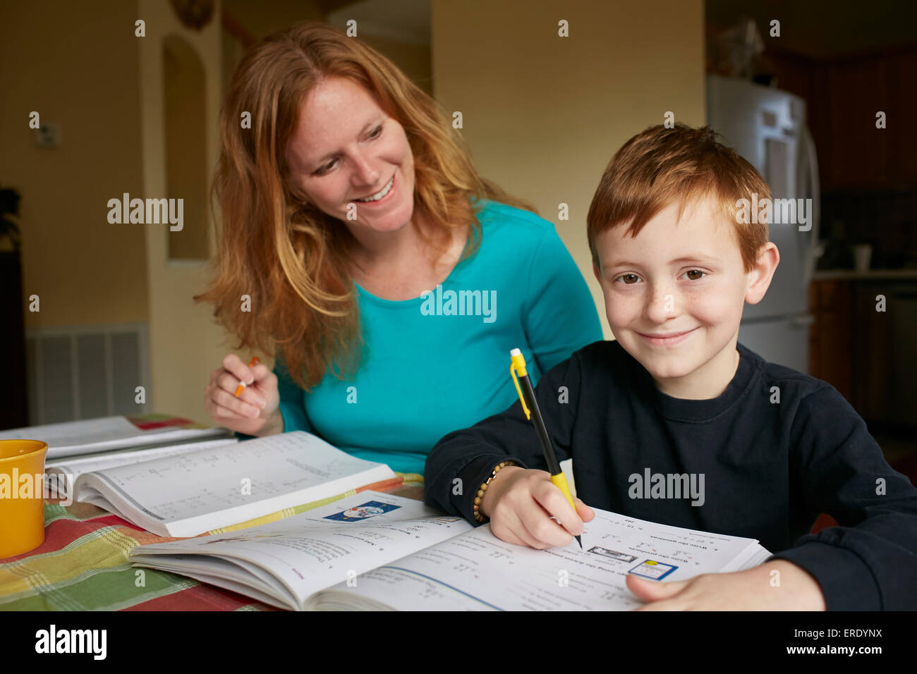 Caucasian mother helping son do homework Stock Photo - Alamy