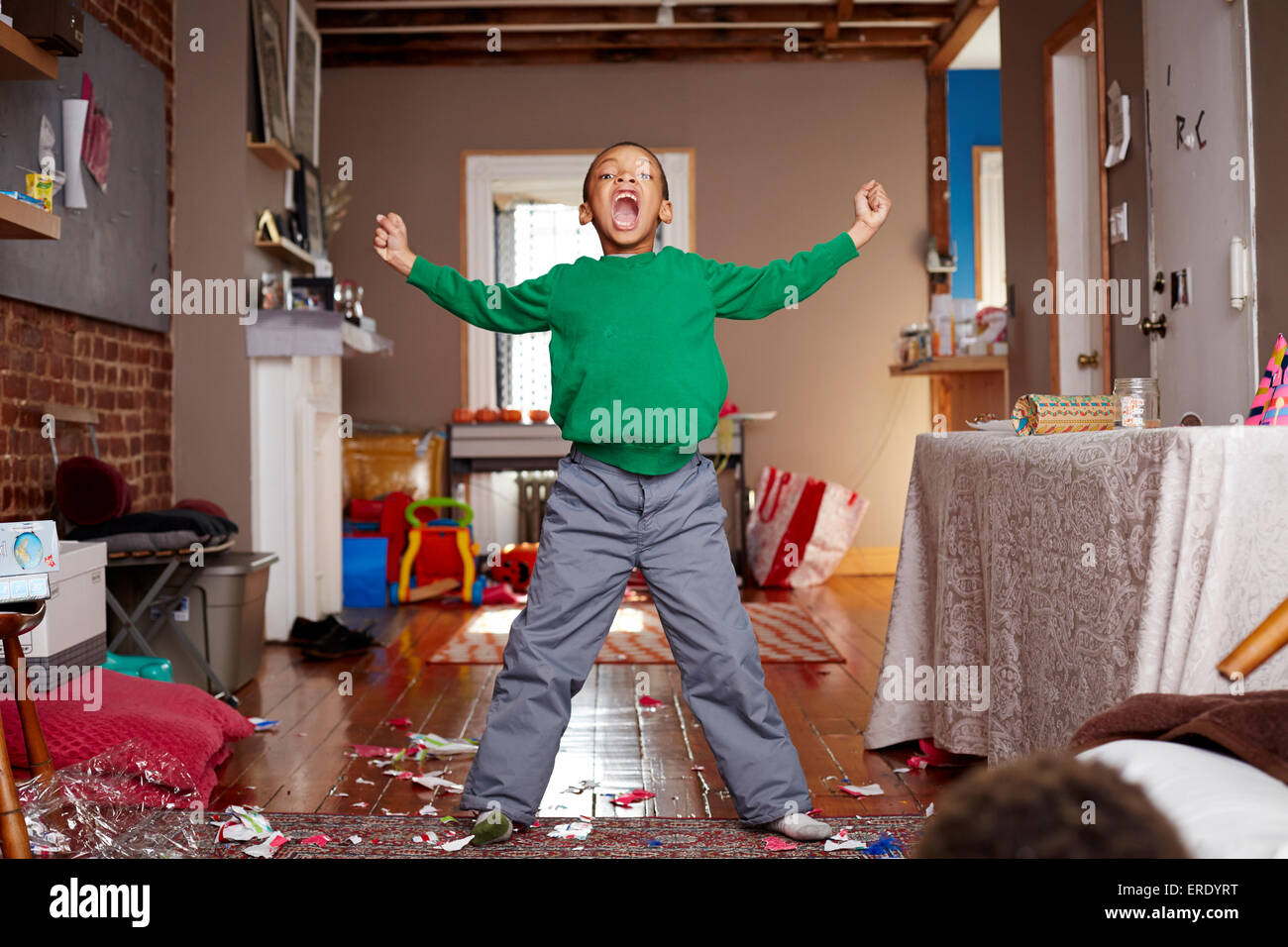 Black boy shouting in living room Stock Photo - Alamy