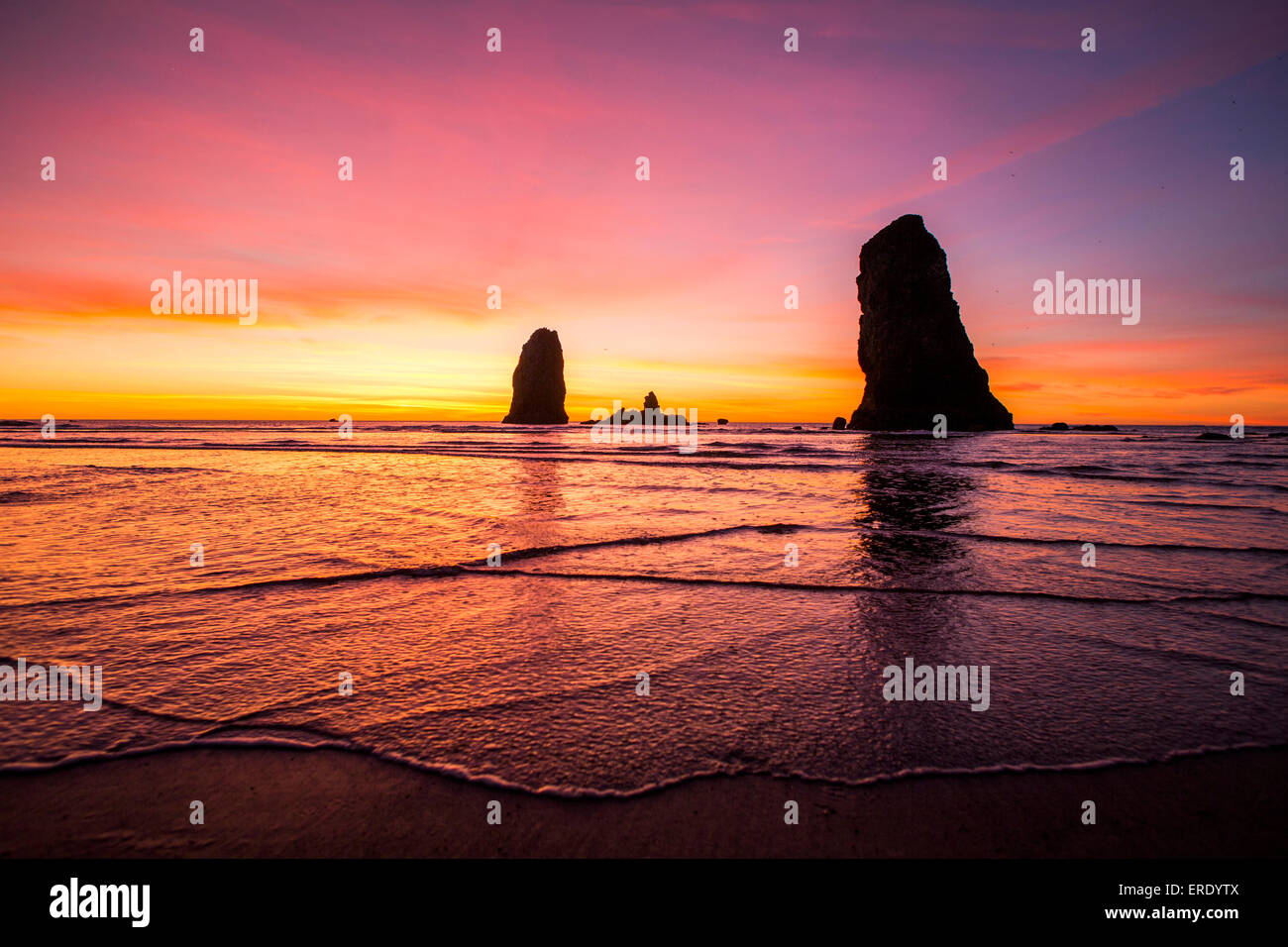 Silhouette of rock formations on Cannon Beach at sunset, Oregon, United ...