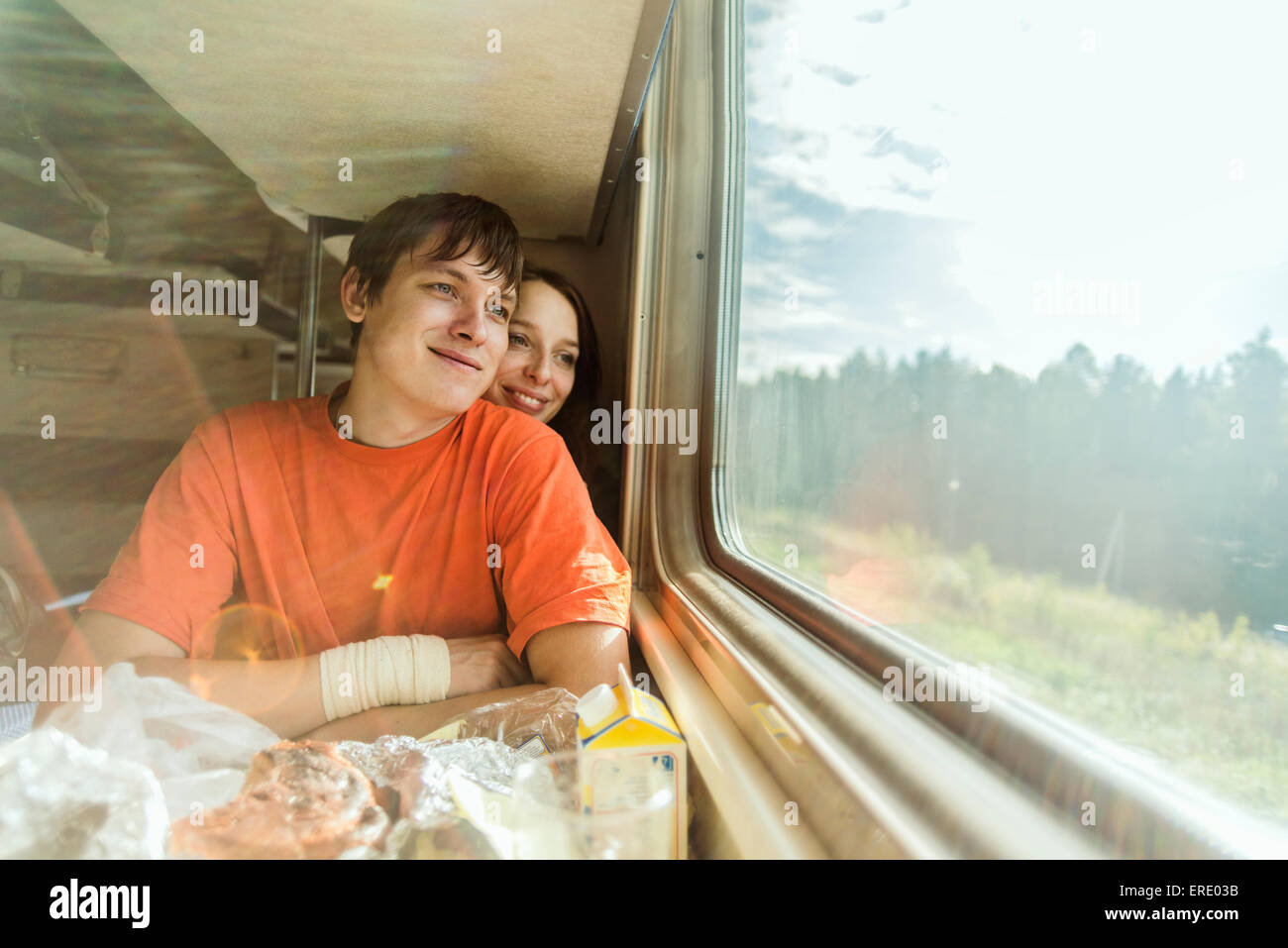 Caucasian couple looking out train window Stock Photo - Alamy
