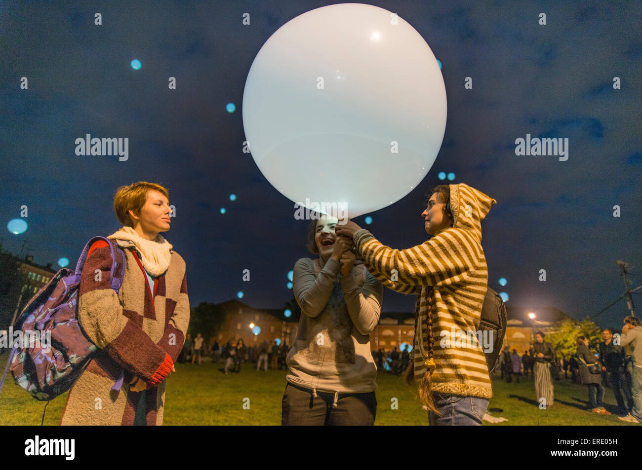 Caucasian friends playing with balloon in park Stock Photo - Alamy