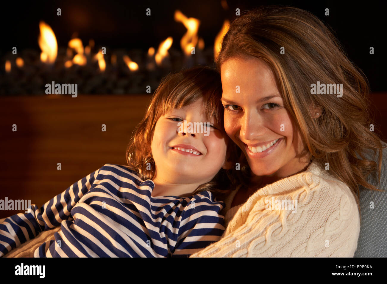 Portrait mother and son by firelight Stock Photo - Alamy