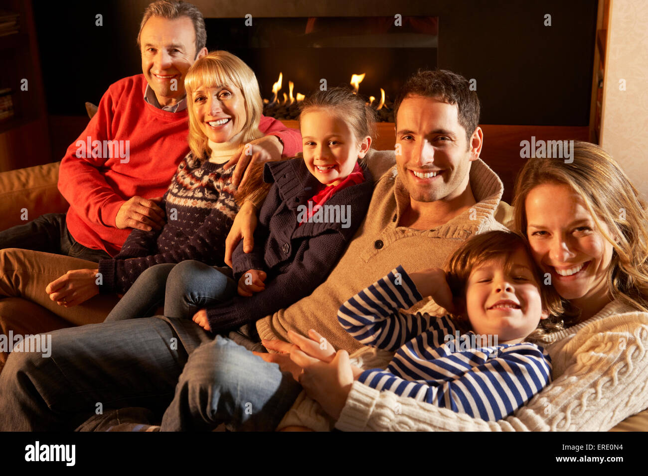 Portrait 3 generation family at home by firelight Stock Photo - Alamy