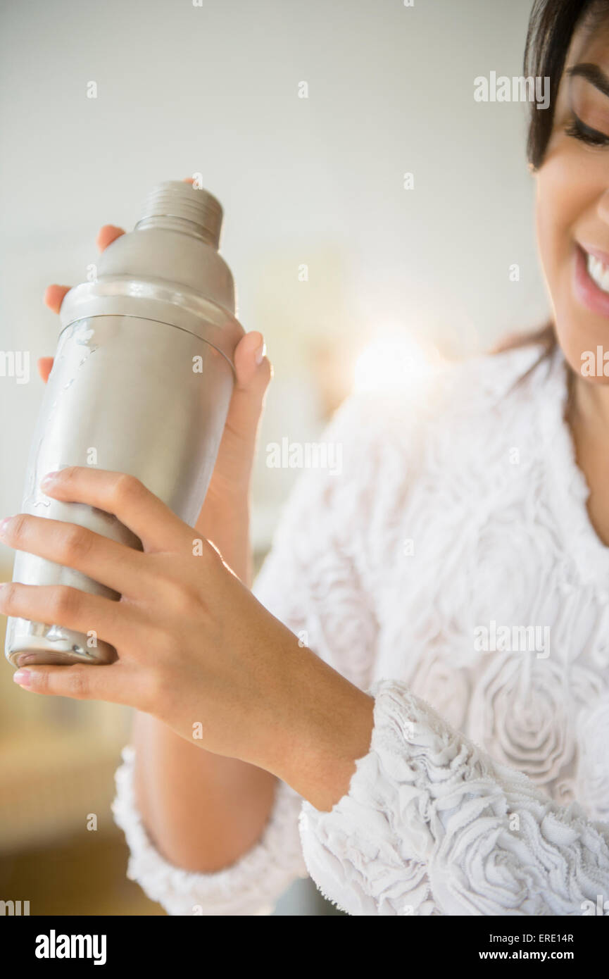 Pacific Islander woman shaking cocktail shaker Stock Photo - Alamy
