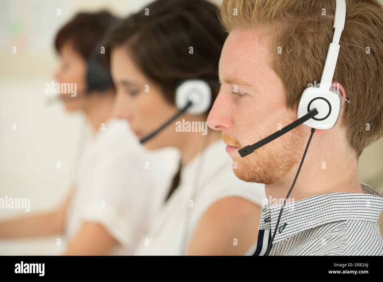 Close up of business people wearing headsets Stock Photo - Alamy