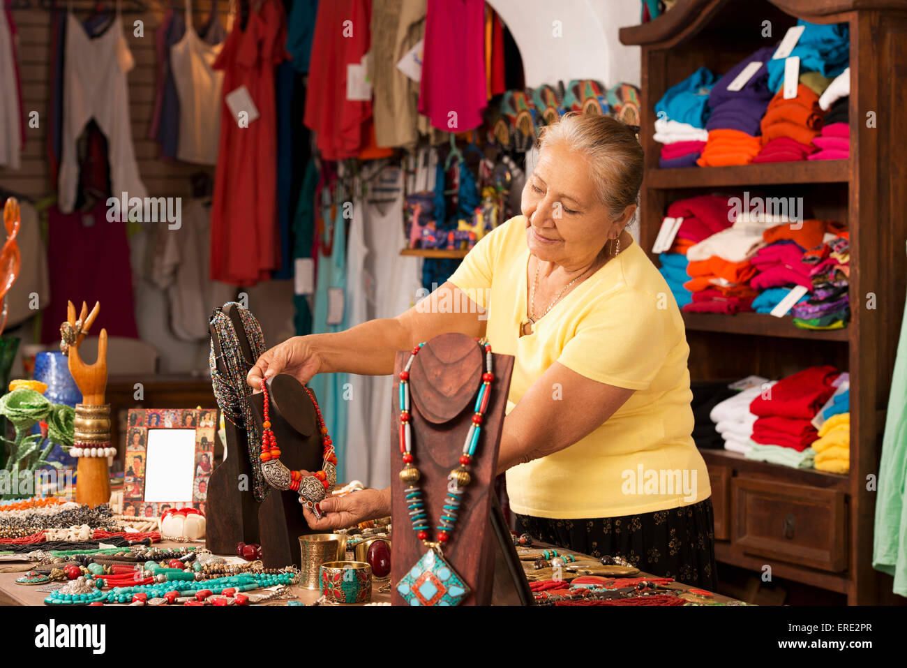 Smiling woman working in traditional gift shop Stock Photo - Alamy