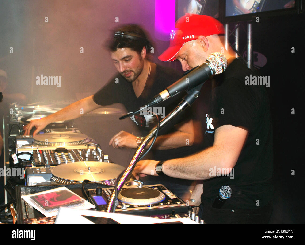 Professional DJs demonstrating equipment at professional audio trade ...