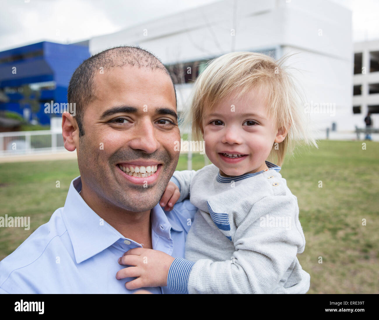 Hispanic father and son smiling in field Stock Photo - Alamy
