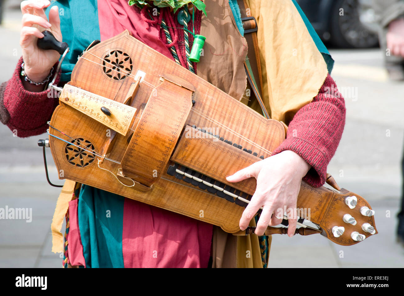 Woman playing a hurdy gurdy in fancy costume taking part in the St ...